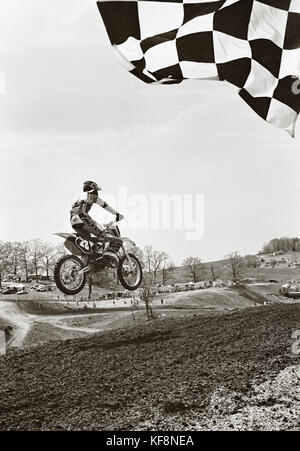 USA, Tennessee, motocross winner jumping across the finish line (B&W ...