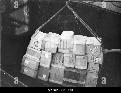 442585 Loading wooden boxes into the hold of a ship Stock Photo - Alamy