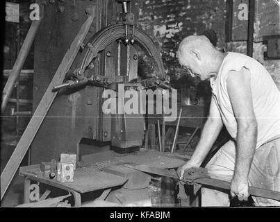 This photograph depicts the making of golf clubs at East Bros, located ...