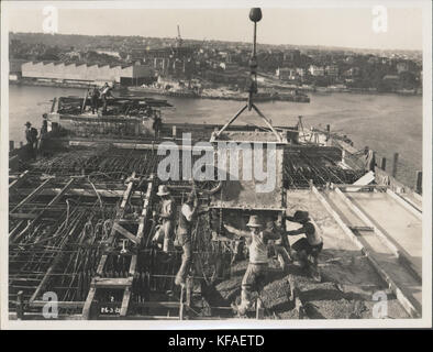 Pouring concrete on the southern platform of the Sydney Harbour Bridge ...