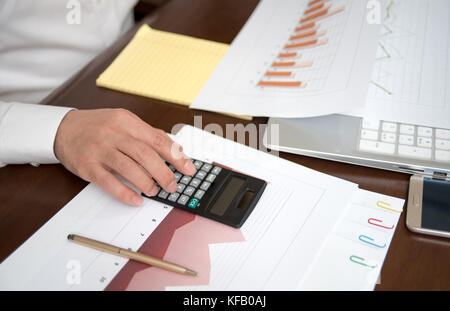 financial adviser working with calculator, business document at office ...