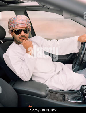 OMAN, Muscat, young man in traditional clothing fishing on boat Stock ...