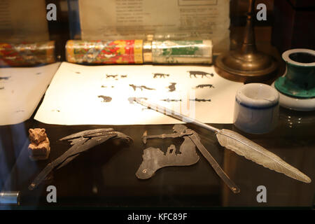 Medieval quill pen for writing in inkwell from horn on wooden desk ...