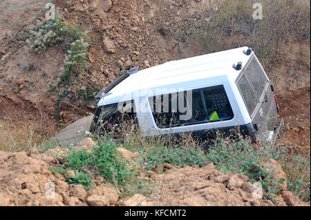 Large excavator digging hole sparks cars on trial grounds Stock Photo ...
