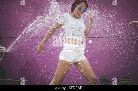 Young woman being sprayed with water Stock Photo - Alamy