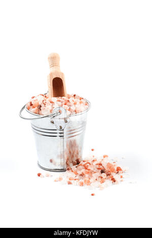 a silver metal spoon with too much salt in it on a marble table ...