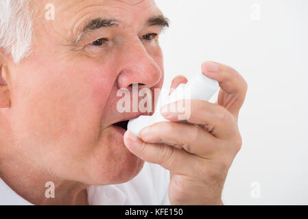 Old man using asthma inhaler Stock Photo - Alamy
