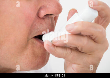 Old man using asthma inhaler Stock Photo - Alamy