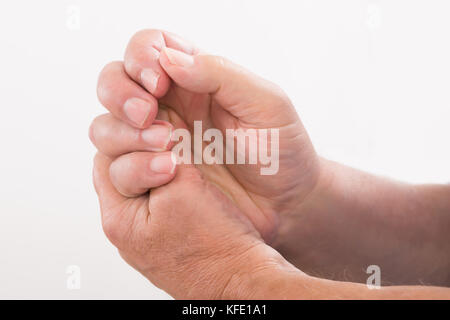 Close-up Of Person Pressing Palm With Thumb On White Background Stock ...