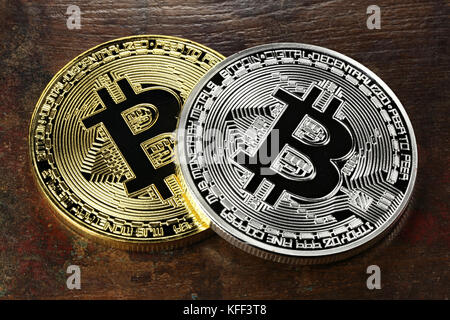 Two bitcoins silver and gold on yellow background Stock Photo - Alamy
