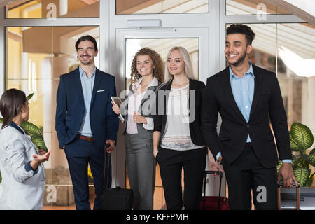 Hotel Administrator Welcome Business People In Lobby, Mix Race ...