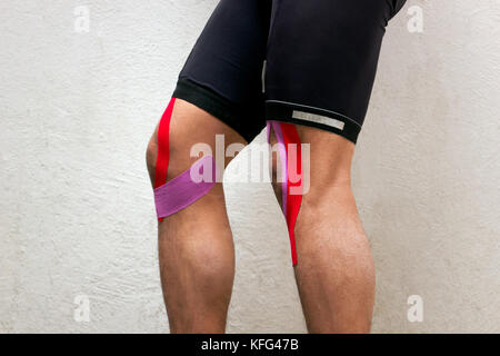 Horizontal photo of a male cyclist with kinesio tape on his hamstring ...