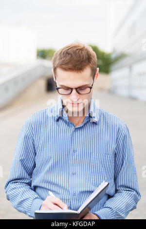 Male journalist interviews and take notes in a notebook Stock Photo - Alamy