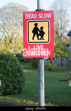 Dead slow, live children speed warning sign Stock Photo - Alamy