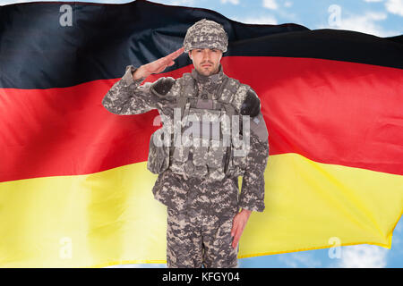 Portrait Of German Soldier Saluting In Front Of Flag Stock Photo - Alamy