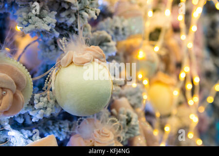 Christmas tree decorated with soft balls and lights, garland closeup ...