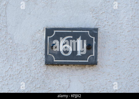 House number 61 sign on wall Stock Photo - Alamy