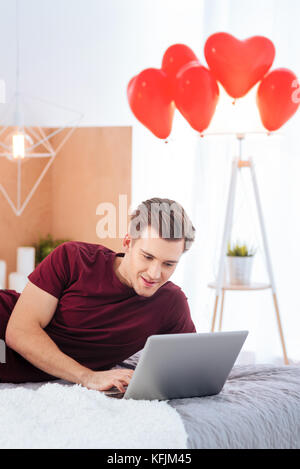 Enthusiastic boy using laptop at home Stock Photo - Alamy