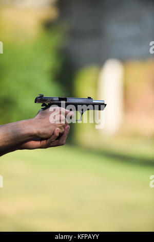 9mm pistol and shooting target, vertical photo Stock Photo - Alamy