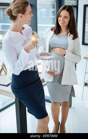 Smiling office colleagues have pleasant conversation discussing work ...