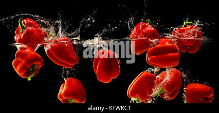 Red bell pepper falling in water with splash on black background Stock ...