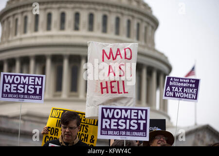 Democrats hold protest signs as President Donald Trump addresses a ...