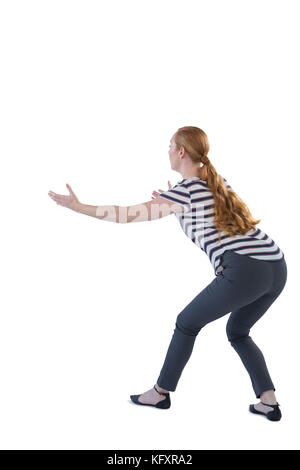 Woman pretending to hold an invisible object against white background ...