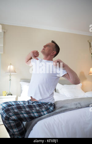 A man waking up in her bed fully rested and open the curtains in the ...
