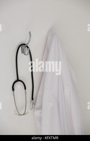 Laboratory coat hanging on hook against wall Stock Photo - Alamy