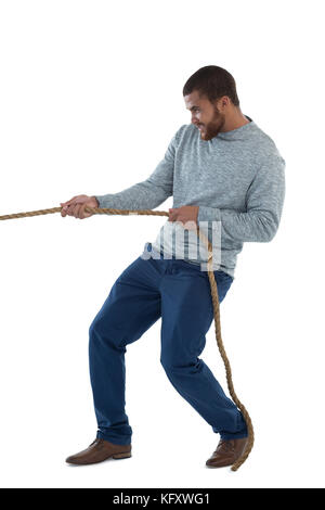 Young male executive pulling the rope against white background Stock ...