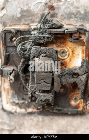 Melted light switch after a house fire. Front view of light regulator ...