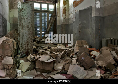 a room full of papers scattered on floor in a room of an abandoned ...