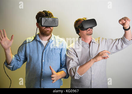 Two men using the Oculus Rift VR headsets, version 2 and 3 Stock Photo ...