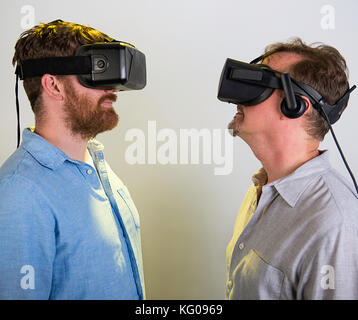 Two men using the Oculus Rift VR headsets, version 2 and 3 Stock Photo ...