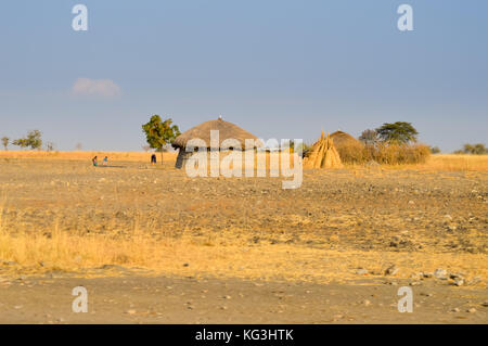 Traditional massai hut made of earth and wood in a rural village of ...