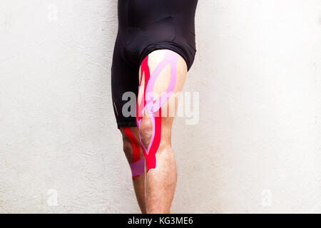 Horizontal photo of a male cyclist with kinesio tape on his hamstring ...