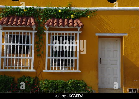 Yellow painted house in Getsemani neighbourhood of Cartagena de Indias ...