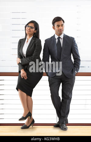 Business couple in formal wear in hotel room Stock Photo - Alamy