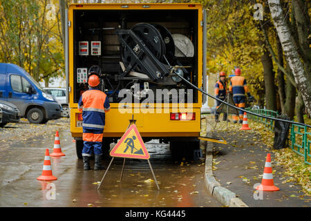 Workers conduct water pipe repair work in the street Stock Photo - Alamy