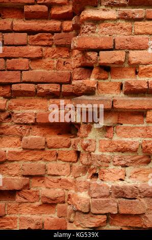 old red brick falling apart wall texture background Stock Photo - Alamy