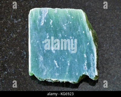 raw nephrite stone slab on dark background Stock Photo - Alamy