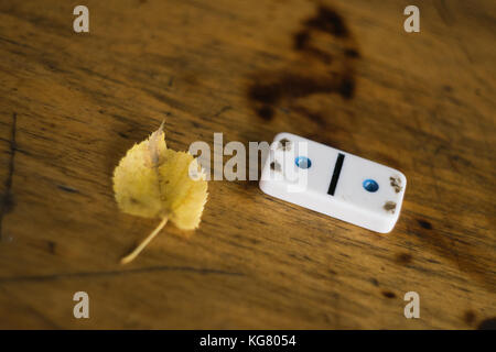 Falling domino on old outdoor table waiting for game Stock Photo - Alamy