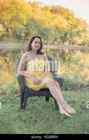 A vertical shot of yellow autumn trees with hills covered by trees in ...