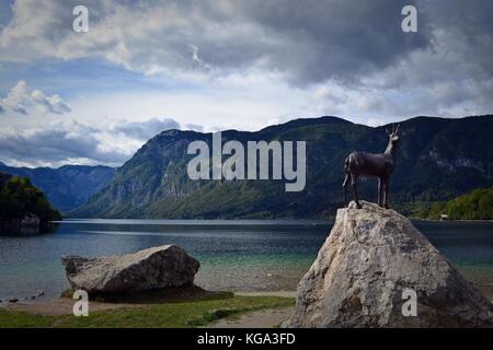 Zlatorog or Golden Horn statue guarding the mountain ridges above Lake ...