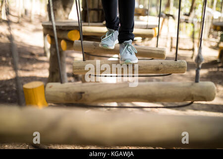 Low section of kid crossing zip line on a sunny day Stock Photo - Alamy