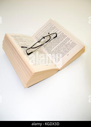 Abstract background with open printed books and blue flowers between ...