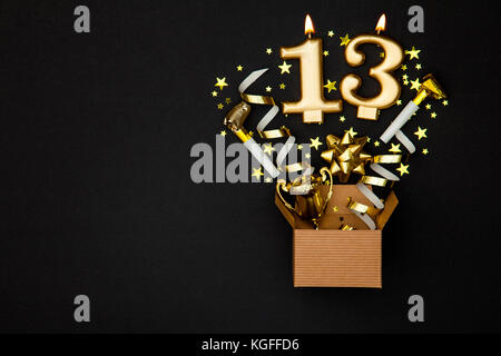 Number 13 gold celebration candle on a glitter background Stock Photo ...