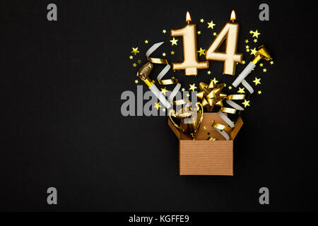 Number 14 gold celebration candle on star and glitter background Stock ...