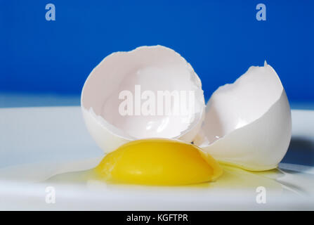 Raw egg yolk inside cracked eggshell in carton box with fresh chicken ...