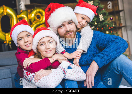 Father and son in santa hats making smartphone christmas video call ...